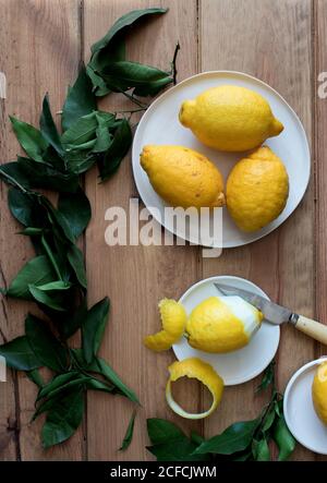 Composition with fresh lemons, peel and juice on pink background Stock ...