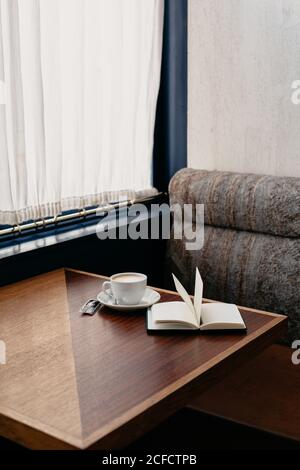 Close-up of coffee on table by window in cafe Stock Photo - Alamy
