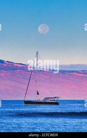 Moon setting over Lahaina Harbor with Lanai in the distance Stock Photo ...