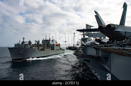 USNS Matthew Perry steams alongside the aircraft carrier USS Nimitz in ...