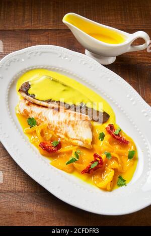 A dish of fish with vegetables Stock Photo - Alamy