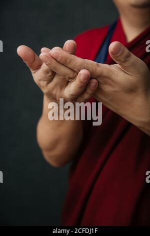 Holy tibetan buddhist gesture mudra palms and fingers and beads, prayer ...