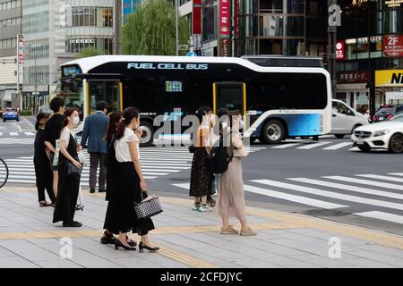 People wait for the hydrogen fuel cell bus at Tokyo Big Sight on March ...