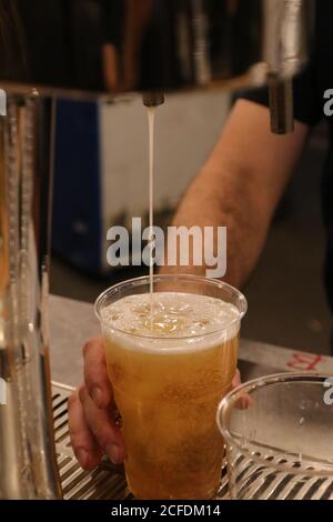Female hand tapping beer during an evening event Stock Photo - Alamy
