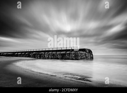 Disused stone jetty on Goleston beach Stock Photo - Alamy