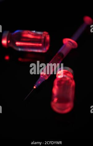 Medical bottles and syringe on light gray tone Stock Photo - Alamy