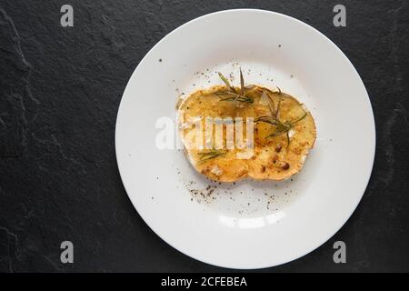 A slice of a giant puffball, Calvatia gigantea, that has been grilled ...