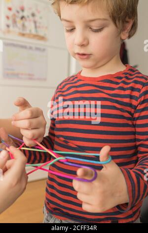 Smart children using rubber bands for game Stock Photo - Alamy