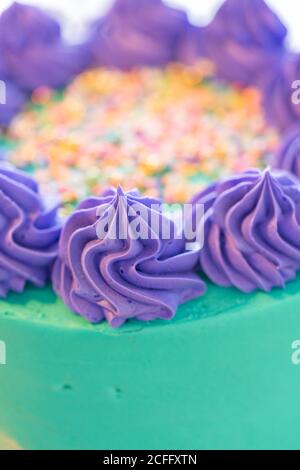 Birthday cake with turquoise buttercream and purple rosettes and ...