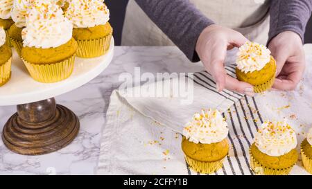 Arranging pumpkin spice cupcake decorated with Italian buttercream ...