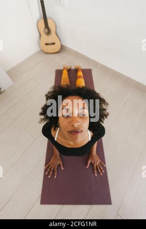 Overhead view of african american woman in a bathrobe relaxing in the ...