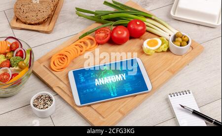 ANATOMY concept in tablet with fruits, top view Stock Photo - Alamy