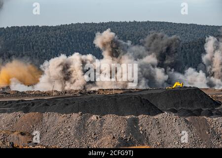 Explosive works on open pit coal mine industry Stock Photo - Alamy