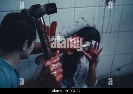 A man with a dagger and a halloween monster face on bokeh lights ...