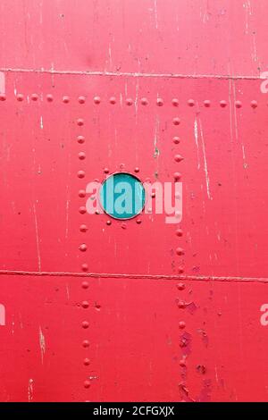 a round porthole window in an iron wall, an elegant modern architecture ...