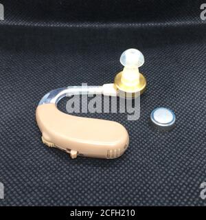 Modern compact in the ear digital audiophone hearing aid in the ear of ...