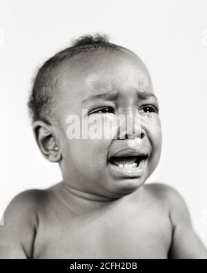 1940s TEETHING AFRICAN-AMERICAN BABY BOY LOOKING AT CAMERA SITTING ...