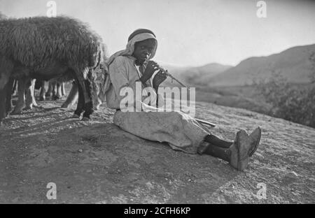 Shepherd playing flute 1925, West Bank, Bethlehem, Israel. Reimagined ...