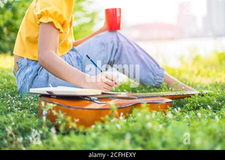 composer write note of song and use acoustic guitar for play Stock ...