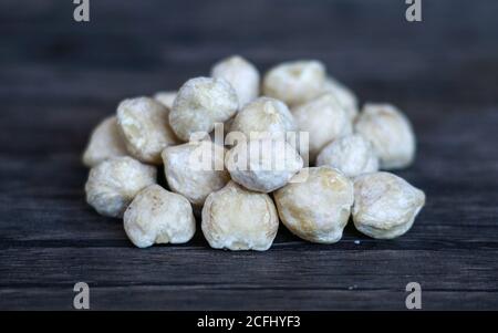 Candlenut or aleurites moluccana on wood background Stock Photo - Alamy