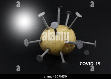Potato with screws forming a COVID-19 virus particle Stock Photo - Alamy