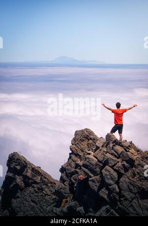 Back view of anonymous male traveler driving modern automobile along ...