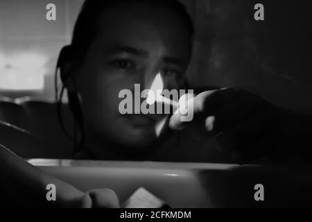 Person Lighting a Match in a Bathtub Stock Photo - Alamy