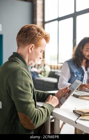 group of young casual software developer sleeping on sofa during a work ...