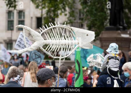 A protester hold a fish skeleton during the demonstration. The groups ...