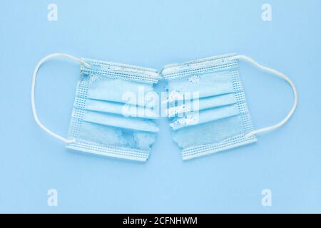 Used, broken, and torn medical face mask. Showing dangerous lack of ppe ...