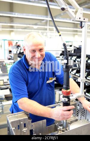 industrial worker assembles electronic components in a factory Stock ...