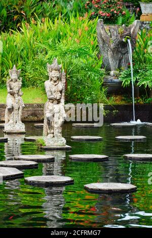 ancient fountain with statues and pond with fish Stock Photo - Alamy