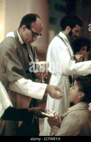 WORSHIPPERS AT HOLY ANGEL CATHOLIC CHURCH ON CHICAGO'S SOUTH SIDE. IT ...