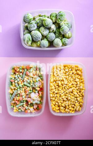 Plastic containers with vegetables on color background Stock Photo - Alamy
