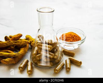 Roots, powder and turmeric pills - Curcuma longa. Space for text Stock ...