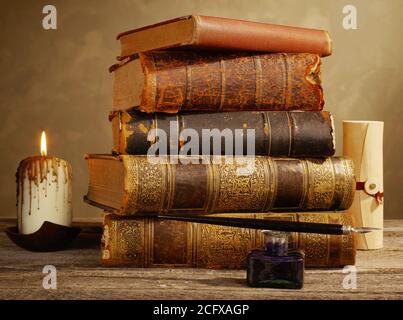 Antique quill pen on stack of leather bound journals Stock Photo - Alamy