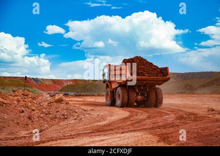 Aluminium ore mining and transporting. Bauxite open-cut mine. Loading ...