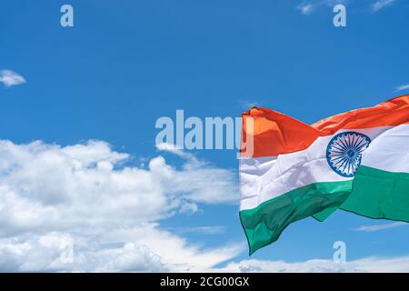 Waving India flag under blue sky background Stock Photo - Alamy
