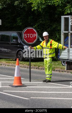 Lollipop Stop And Go Traffic Sign; Traffic Control Workman holding ...