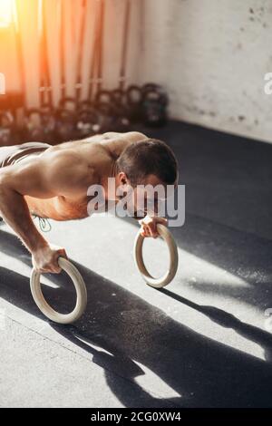 Push up with gymnastic rings in fitness gym Stock Photo - Alamy