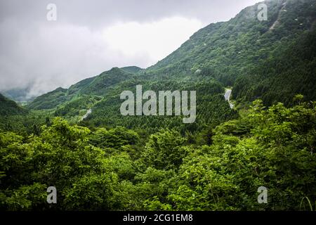 Black tarry roads cutting through green, mountainous country Stock ...