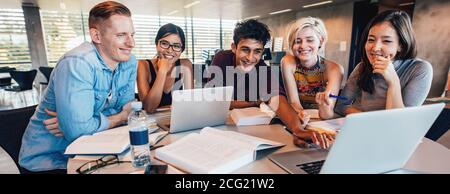 Multiethnic group of people studying together at table . Focus on ...