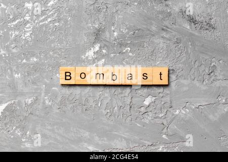 bombast word written on wood block. bombast text on cement table for ...