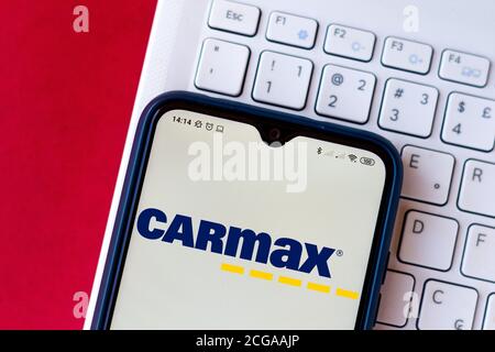 In this photo illustration, the CarMax logo is seen displayed on a ...