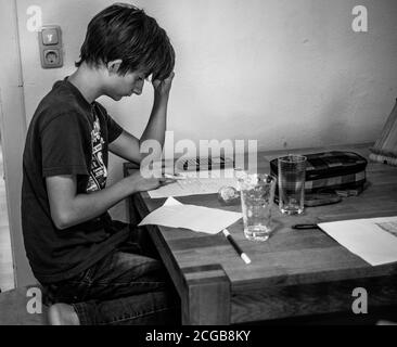 a teenager doing her homework at home after school, in Sint-Denijs ...