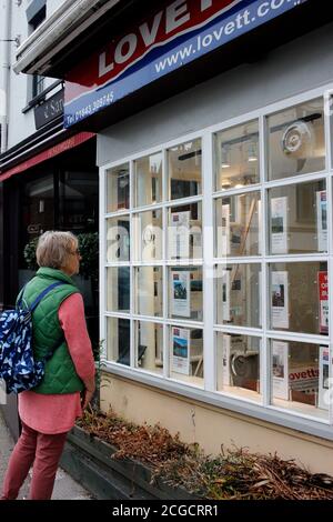 woman viewing a travel agents window display shop, bexhill-on-sea, east ...