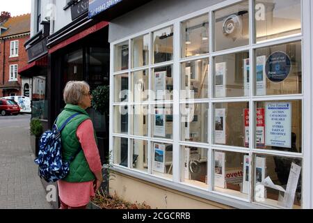 woman viewing a travel agents window display shop, bexhill-on-sea, east ...