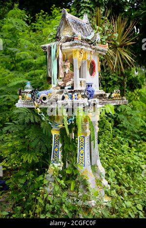 Small spirit house shrine inside a cave in Thailand, used for religious ...