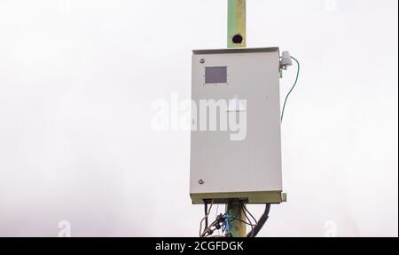 White electric box on a pole outside the house Stock Photo - Alamy