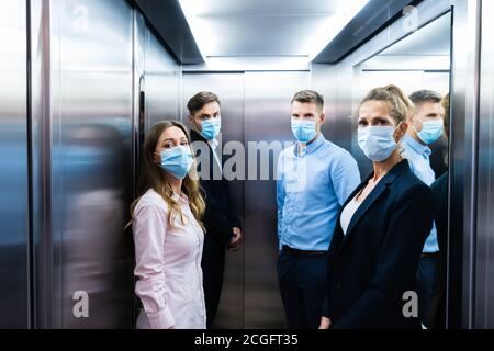 Group Of People In Elevator Wearing Face Masks Stock Photo - Alamy